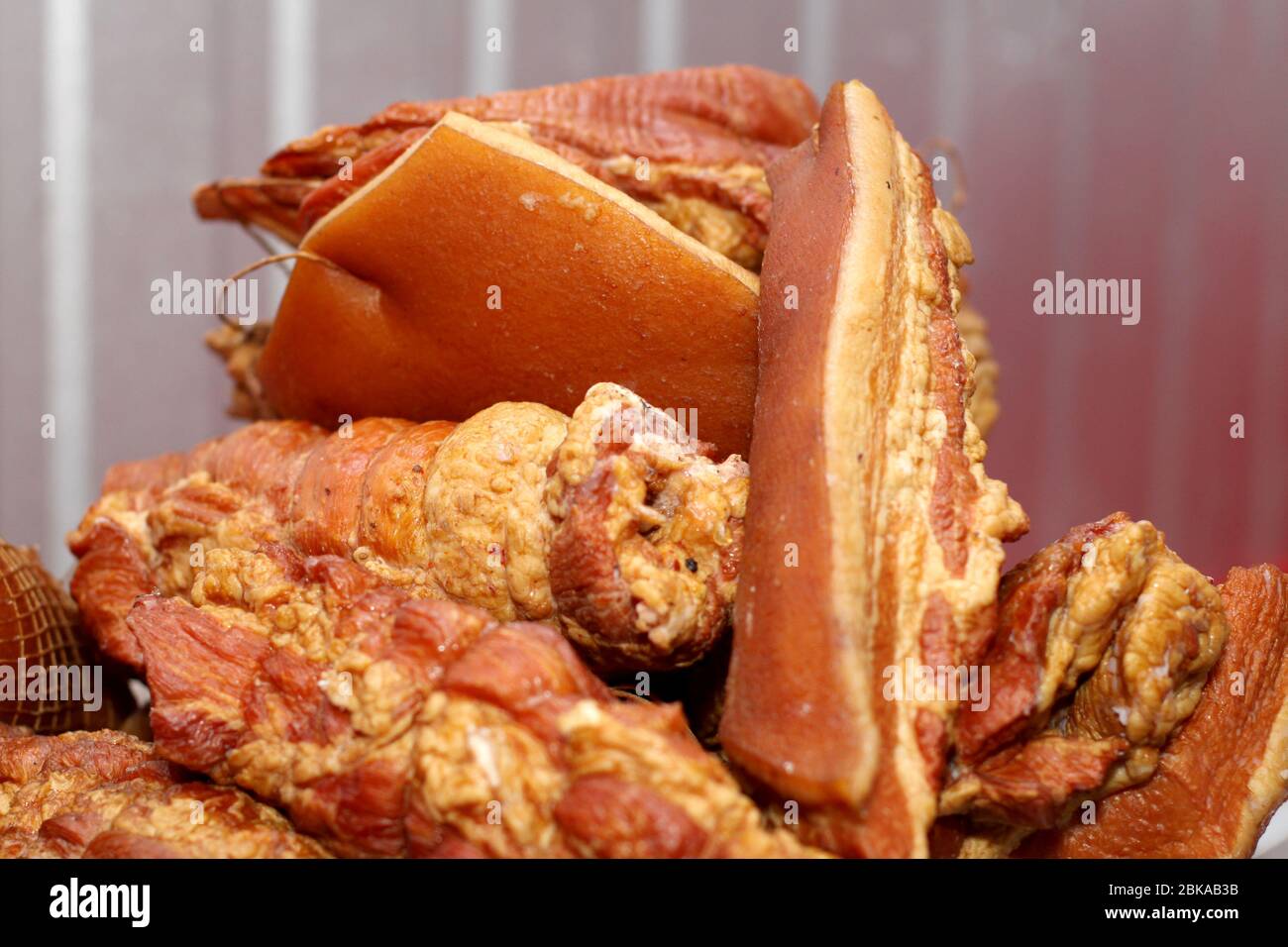 A worker at the meat processing factory, prepares sausages at the work ...