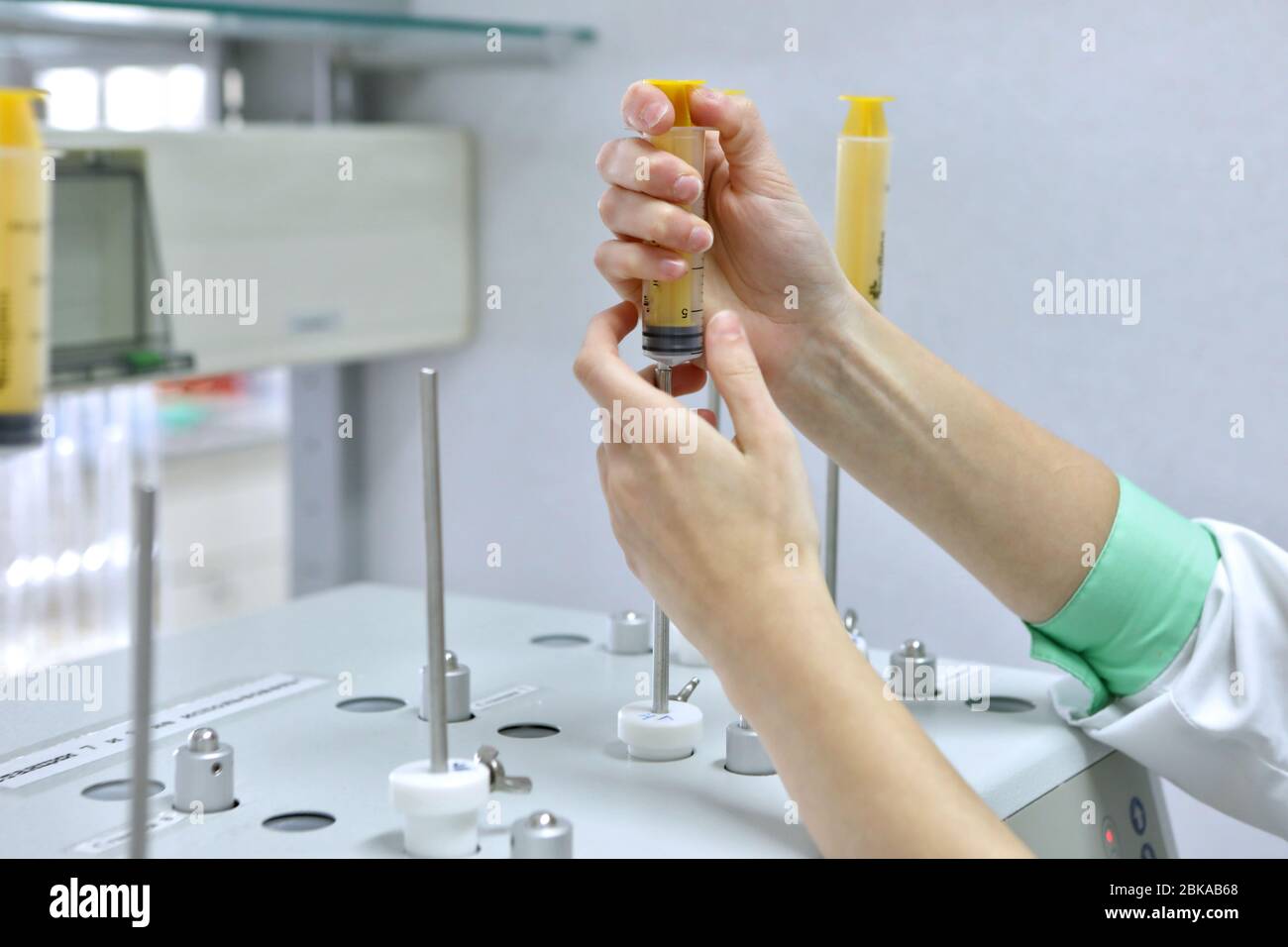 A female chemist conducts solubility tests of tablets and other dosage ...