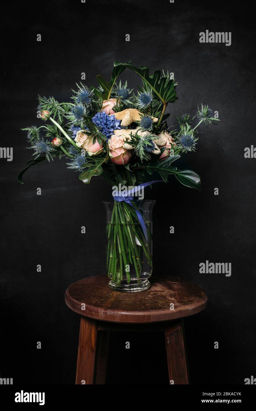 flower Ikibana on a black background, bouquet in a glass vase, ebony ...