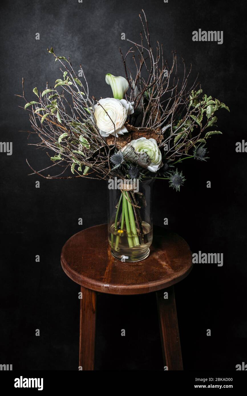 flower Ikibana on a black background, bouquet in a glass vase, ebony ...
