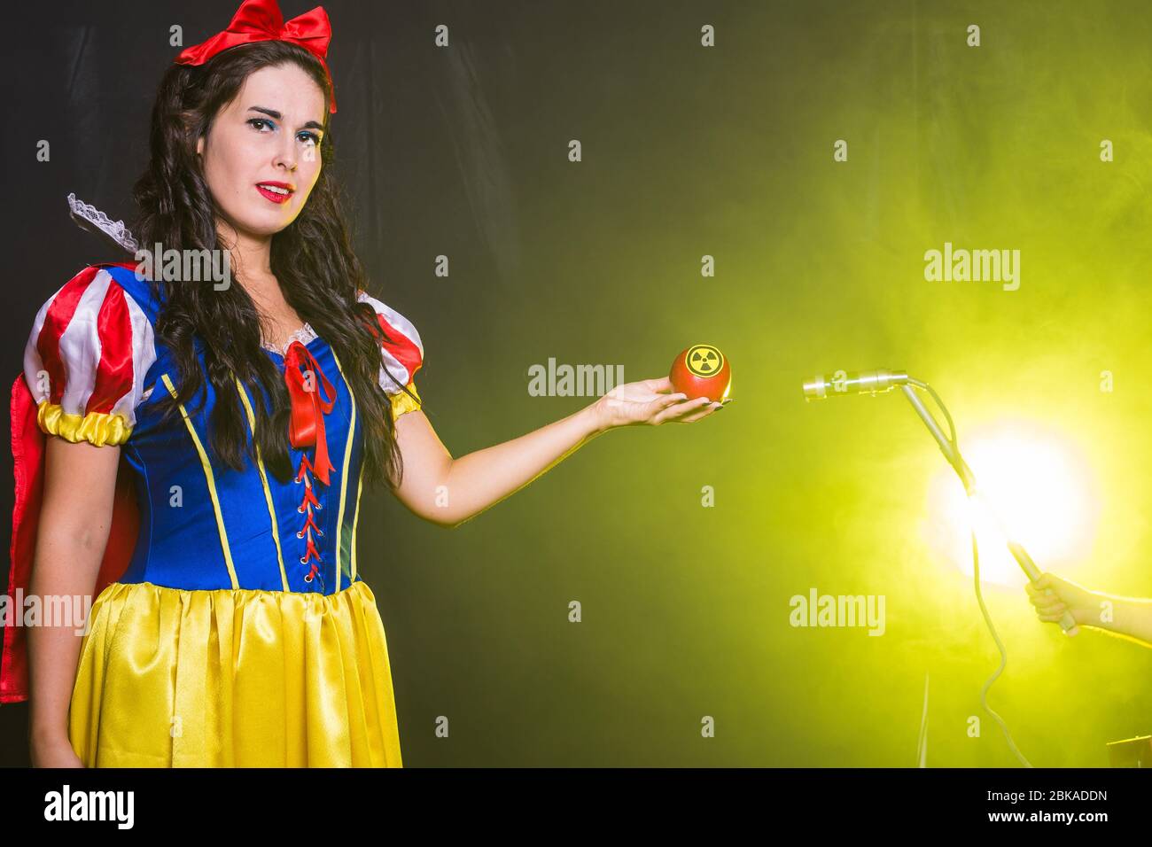 Woman dressed as fairytale character holds Radioactive atomic nuclear ...