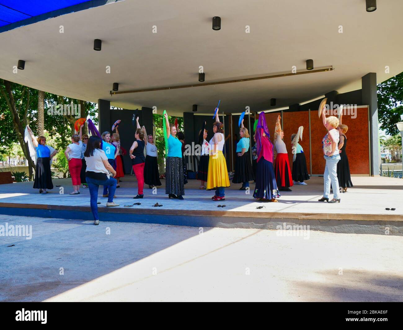 A group of women learn the skills of traditional Spanish dancing on the ...