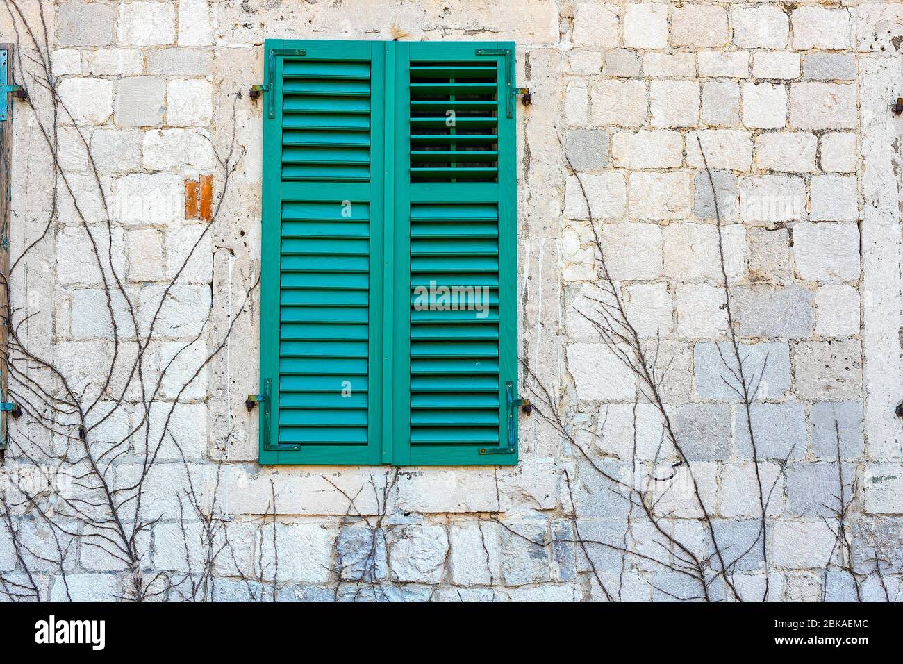 Authentic house with a stone wall, with beautiful old open windows and ...