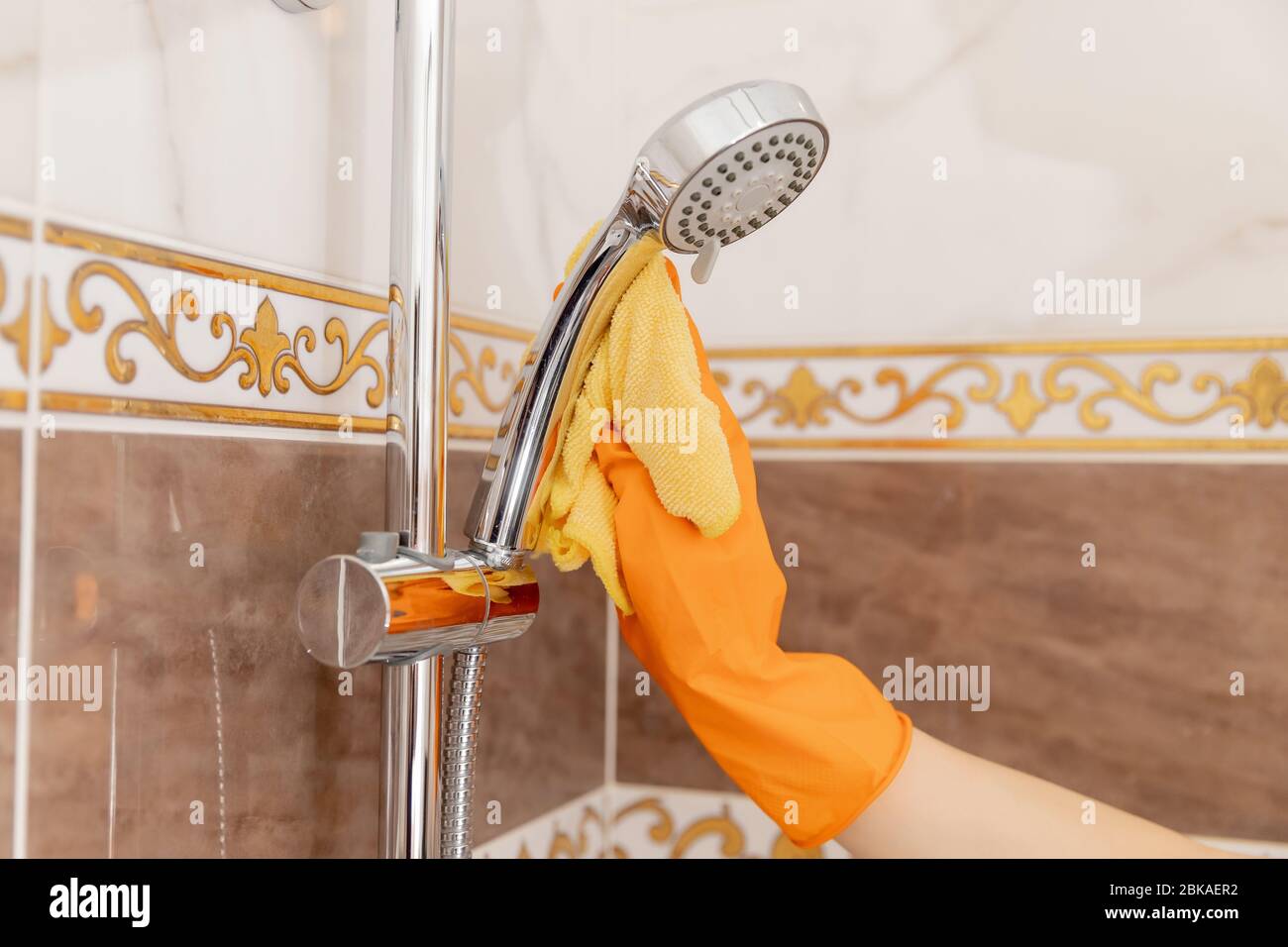 Cleaning tap from limescale in bathroom, disinfecting surface from ...