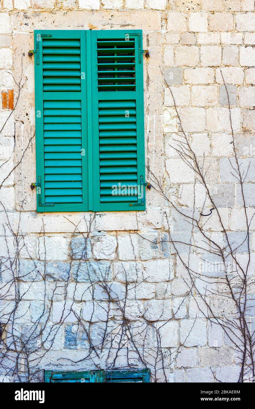 Authentic house with a stone wall, with beautiful old open windows and ...