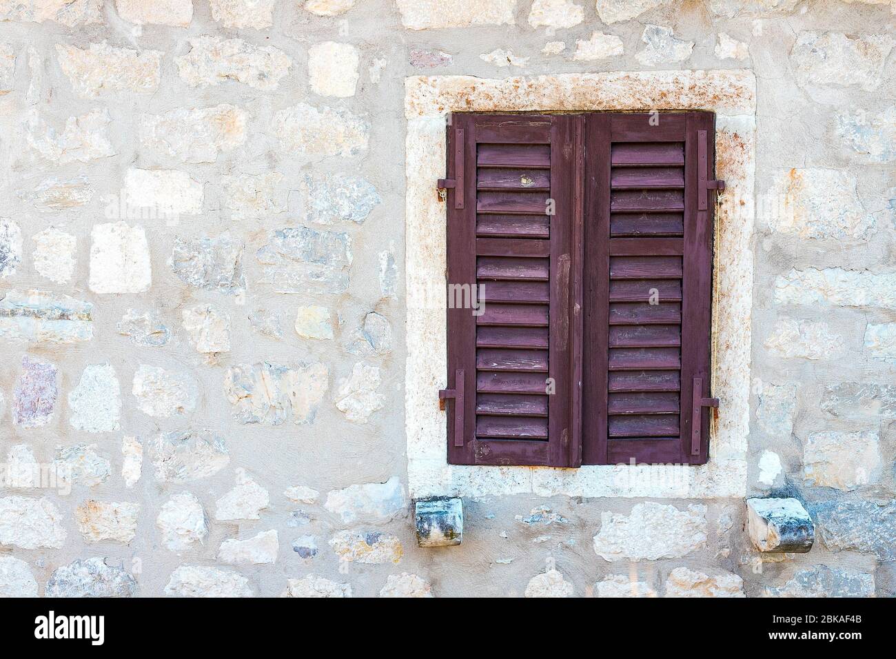 Authentic house with a stone wall, with beautiful old open windows and ...