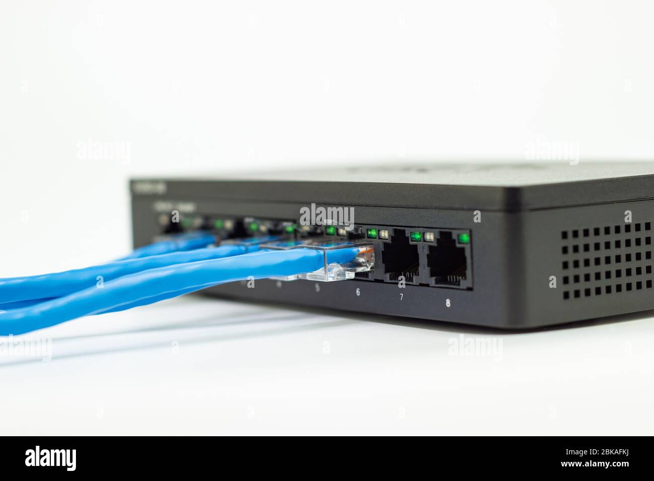 The blue network cables connect port switch on white table concept ...