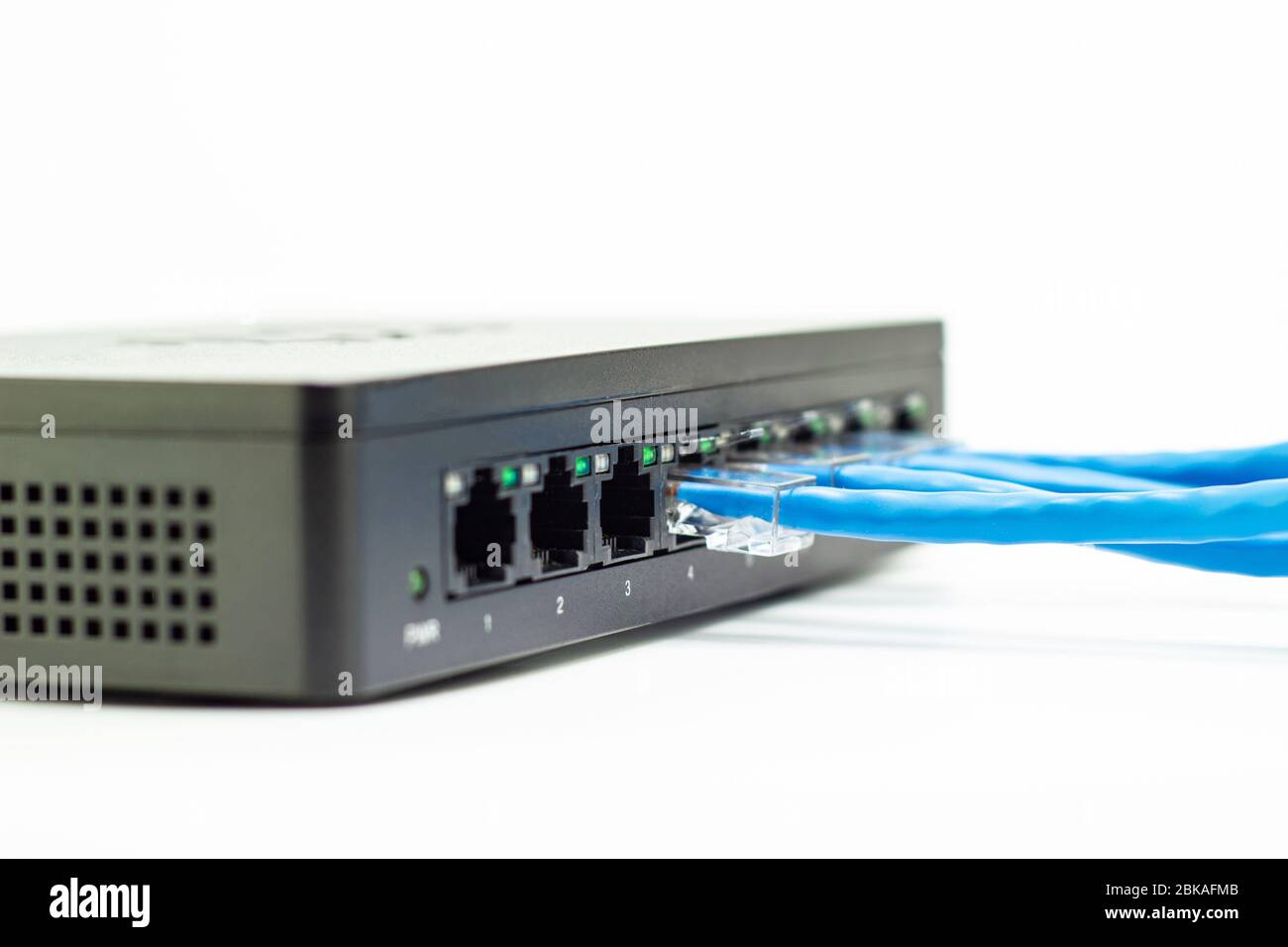 The blue network cables connect port switch on white table concept ...