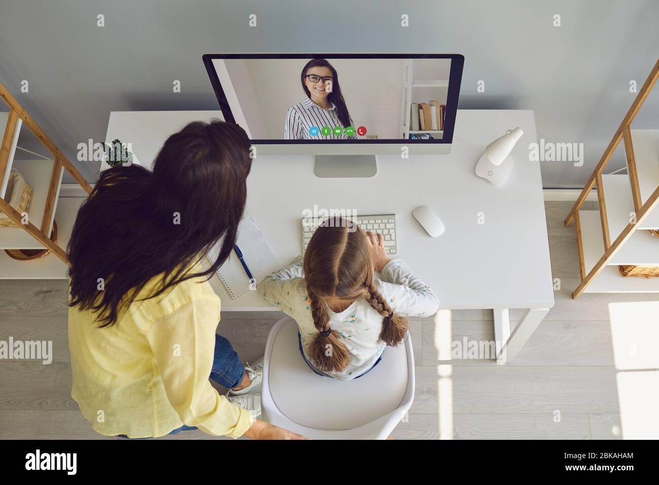 Online learning lessons education school. Mother and daughter are doing ...