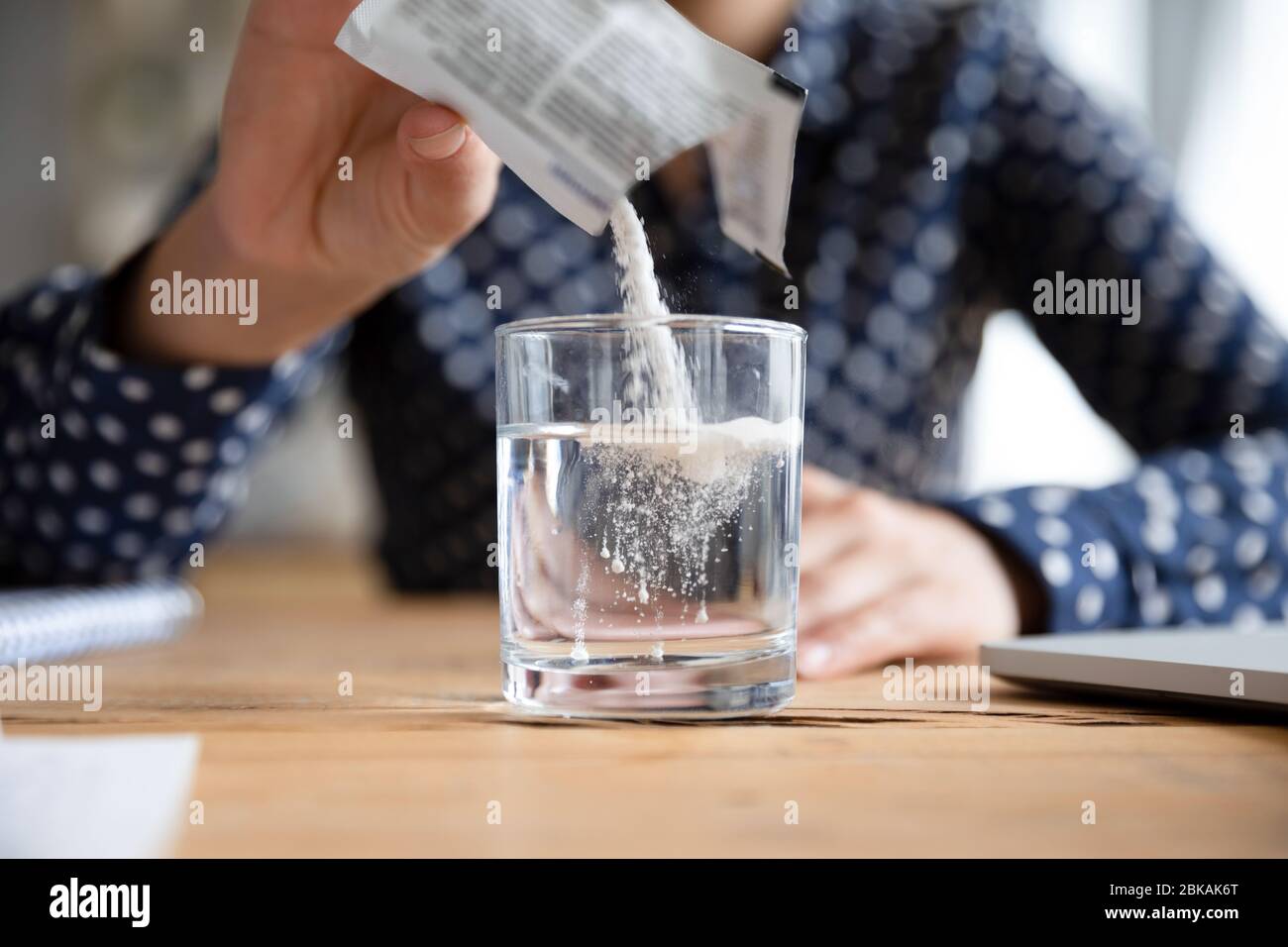 Woman pouring soluble anti-influenza powder in glass of water Stock ...