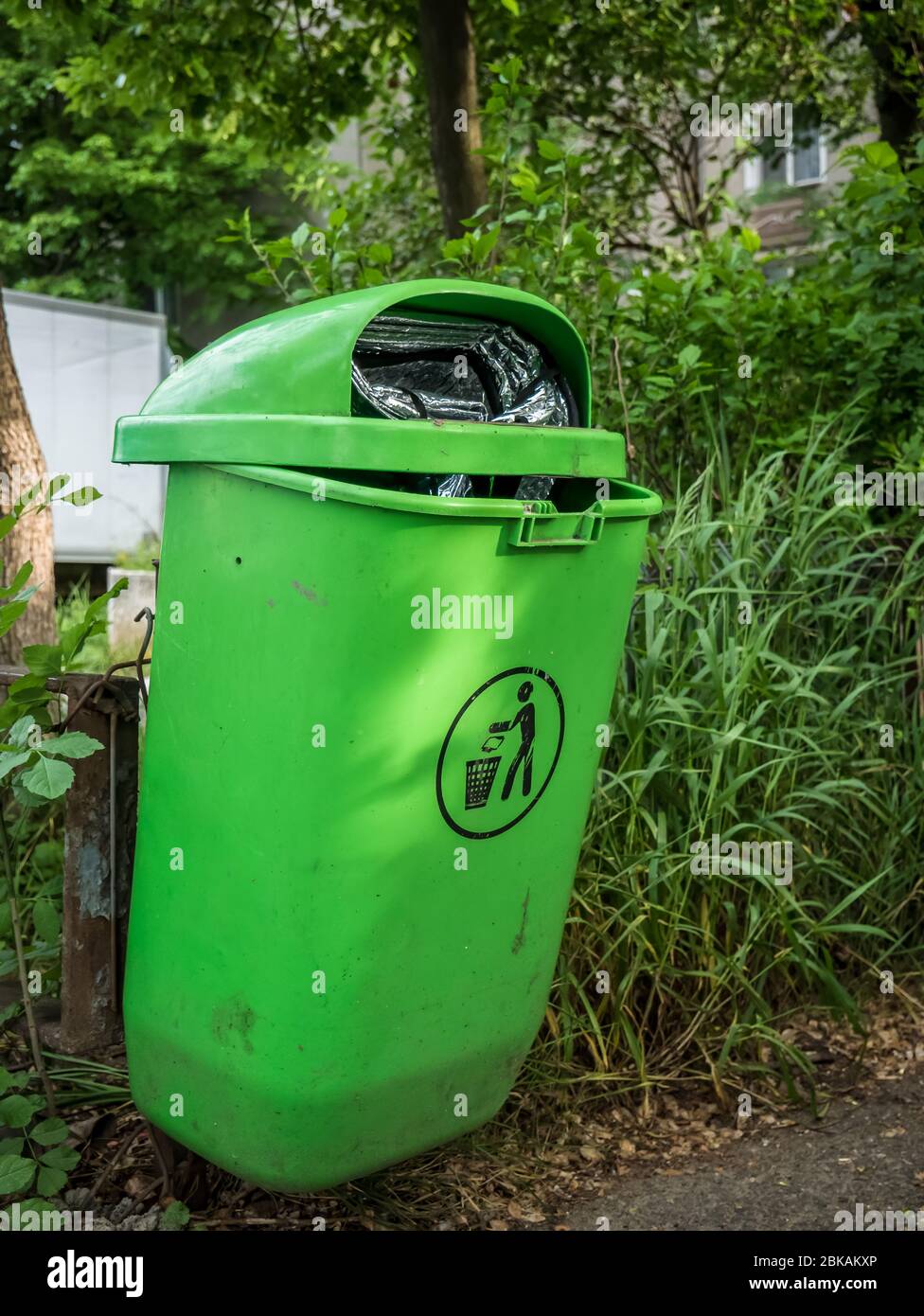 Green garbage bin in Bucharest, Romania Stock Photo - Alamy