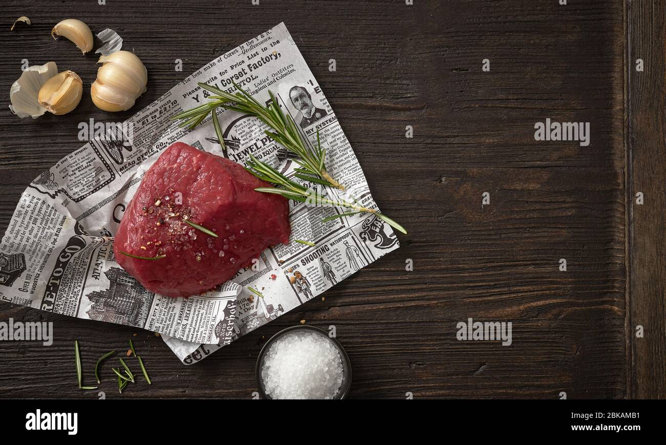 Raw steak on dark wood hi-res stock photography and images - Alamy