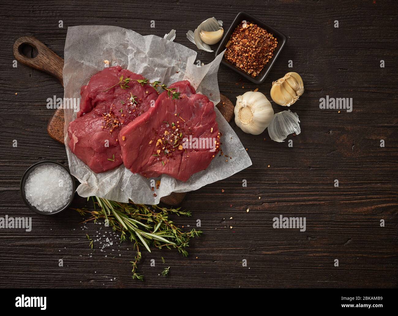 fresh raw beaf steak meat on dark wood kitchen table, top view Stock ...