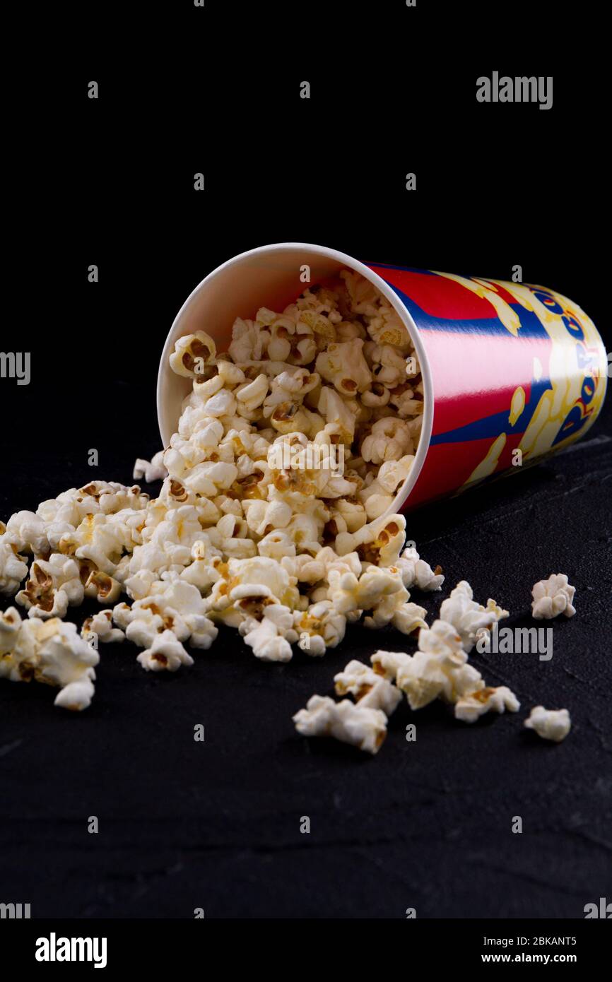 Close up spilled popcorn on black background Stock Photo - Alamy
