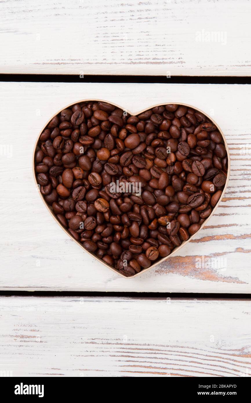 Coffee heart shape on white wood Stock Photo - Alamy