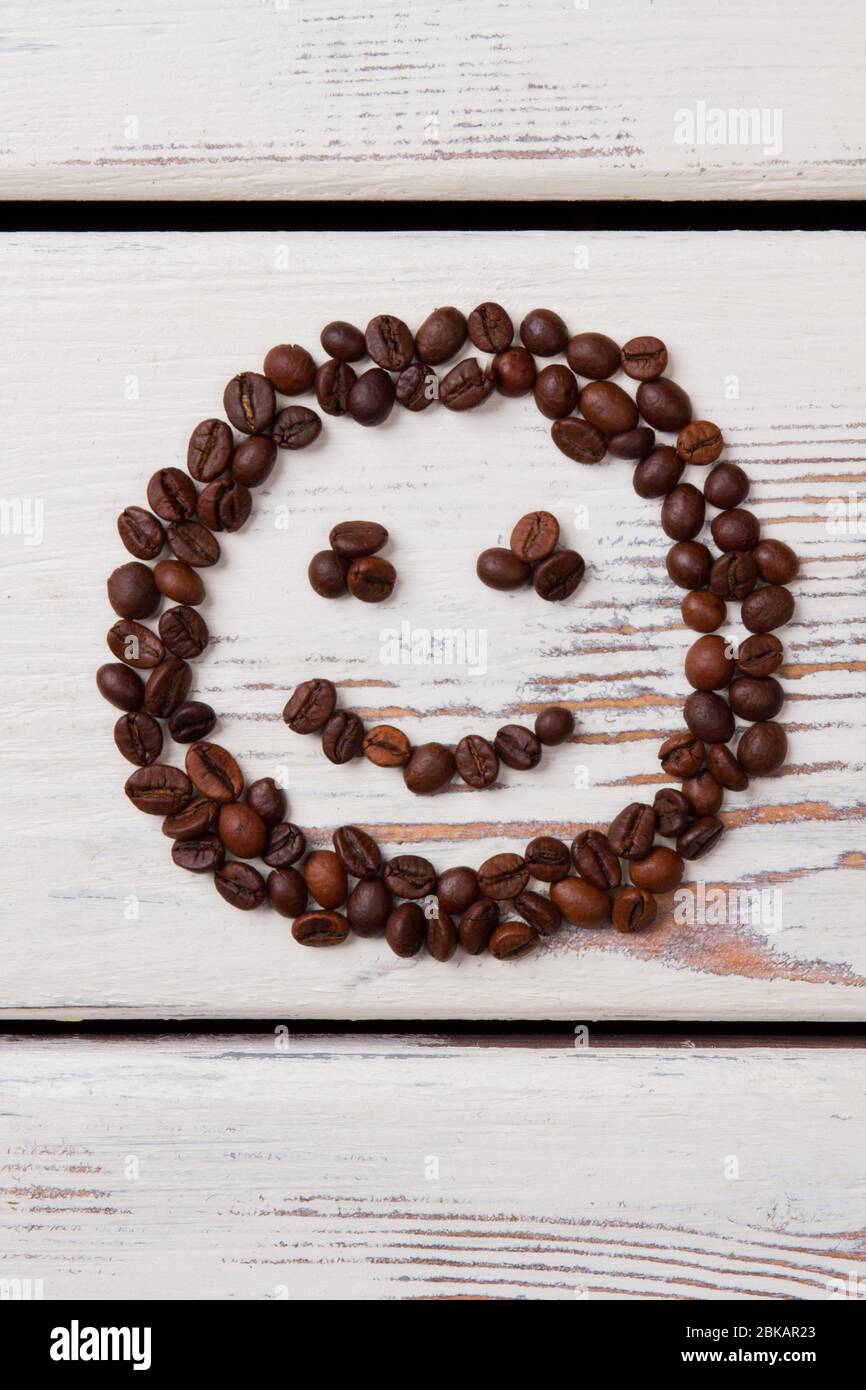 Coffee beans on white planks arranged in a shape of smile face Stock ...