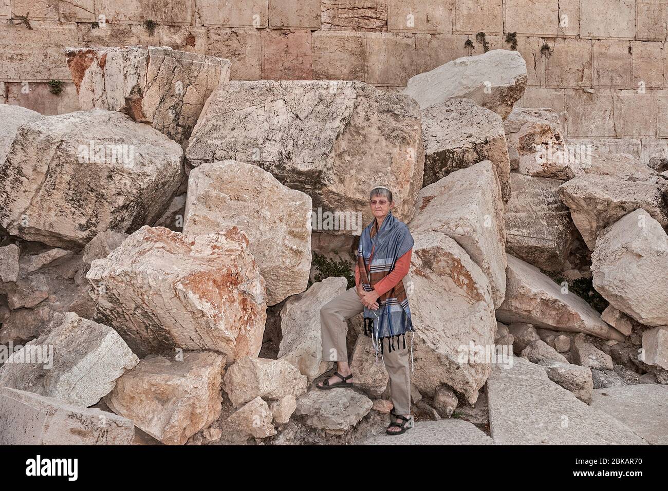 a female rabbi posing on the massive stones thrown down from the temple ...