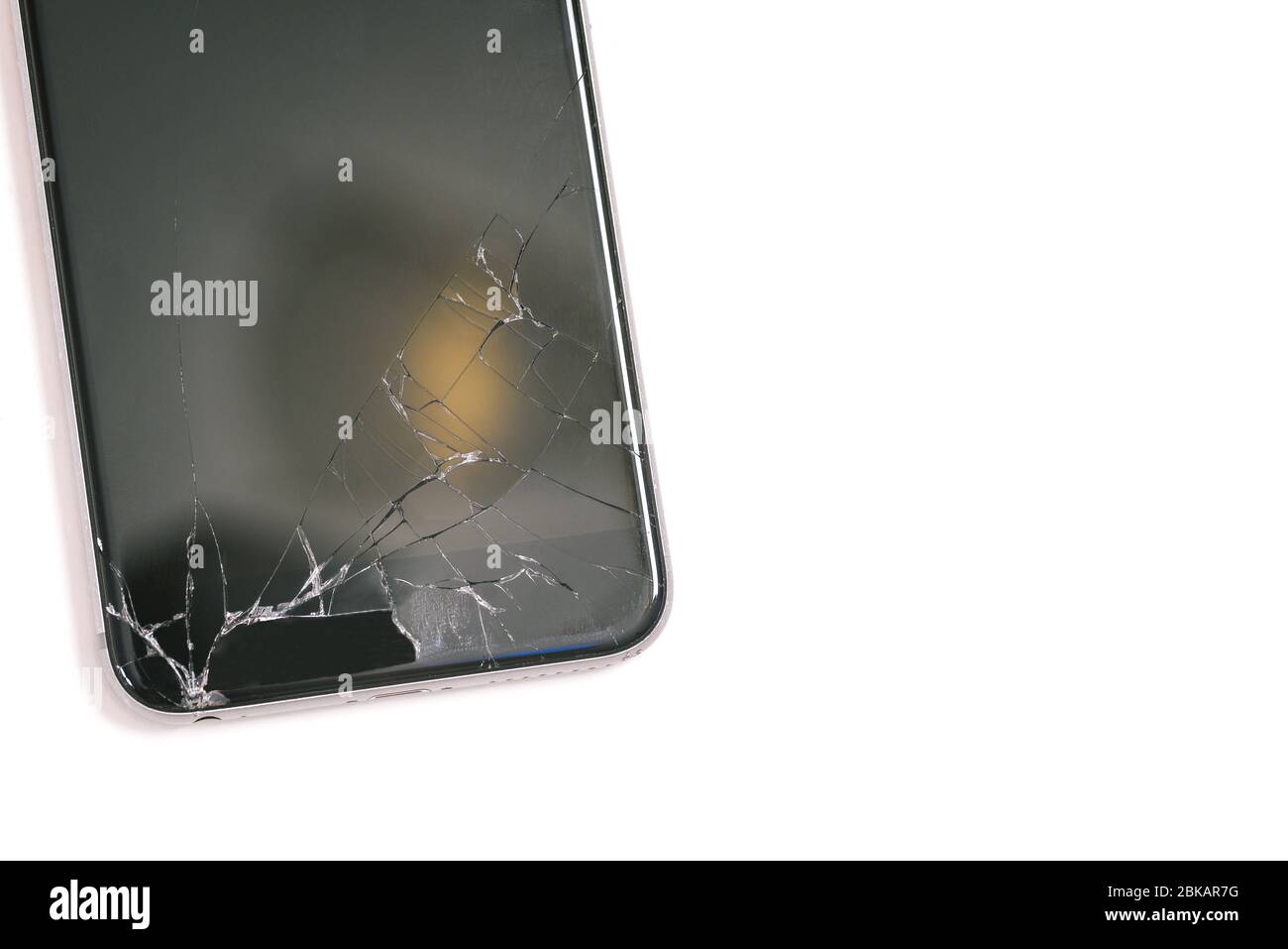 Broken smartphone glass. A broken mobile phone isolated on a white ...