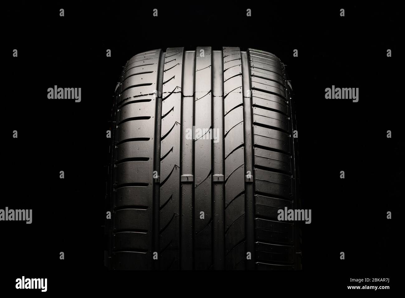 new sports modern tire on a black background Stock Photo - Alamy