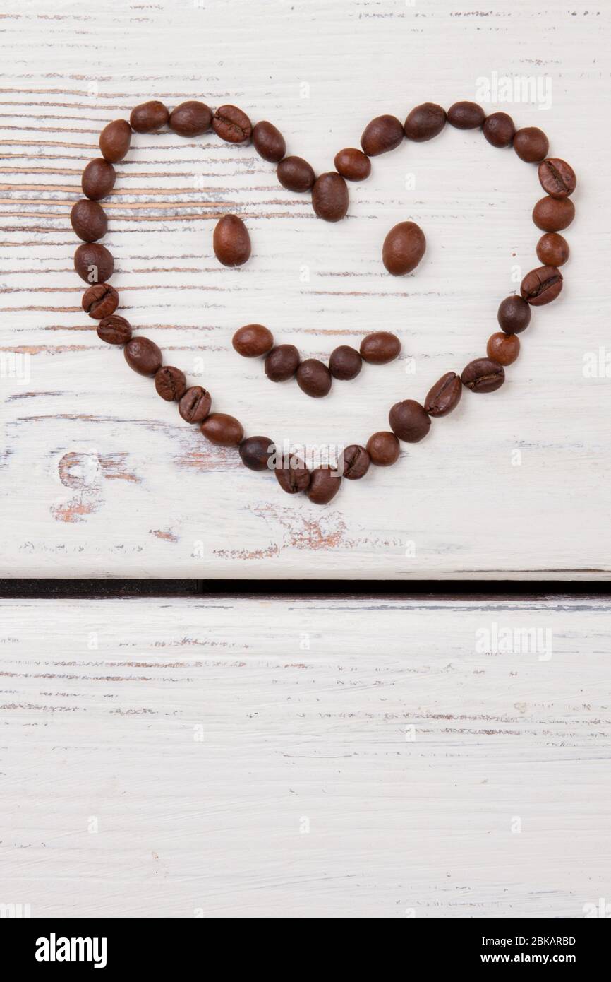 Coffee beans arranged in a shape of smiley with heart-shaped head Stock ...