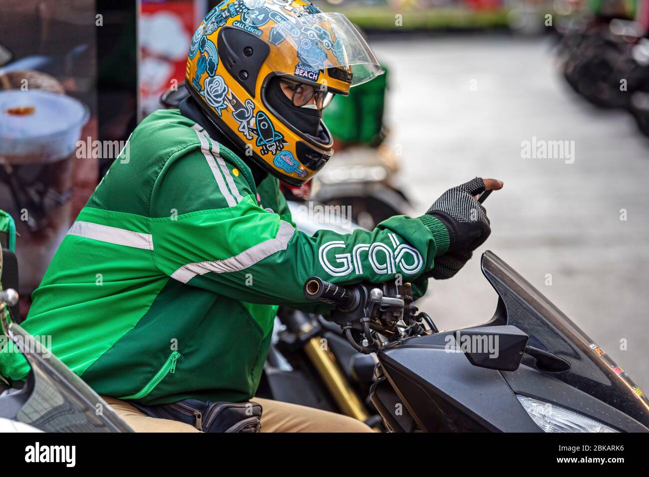 Grab motorcycle delivery riders wearing face mask during Covid 19 ...