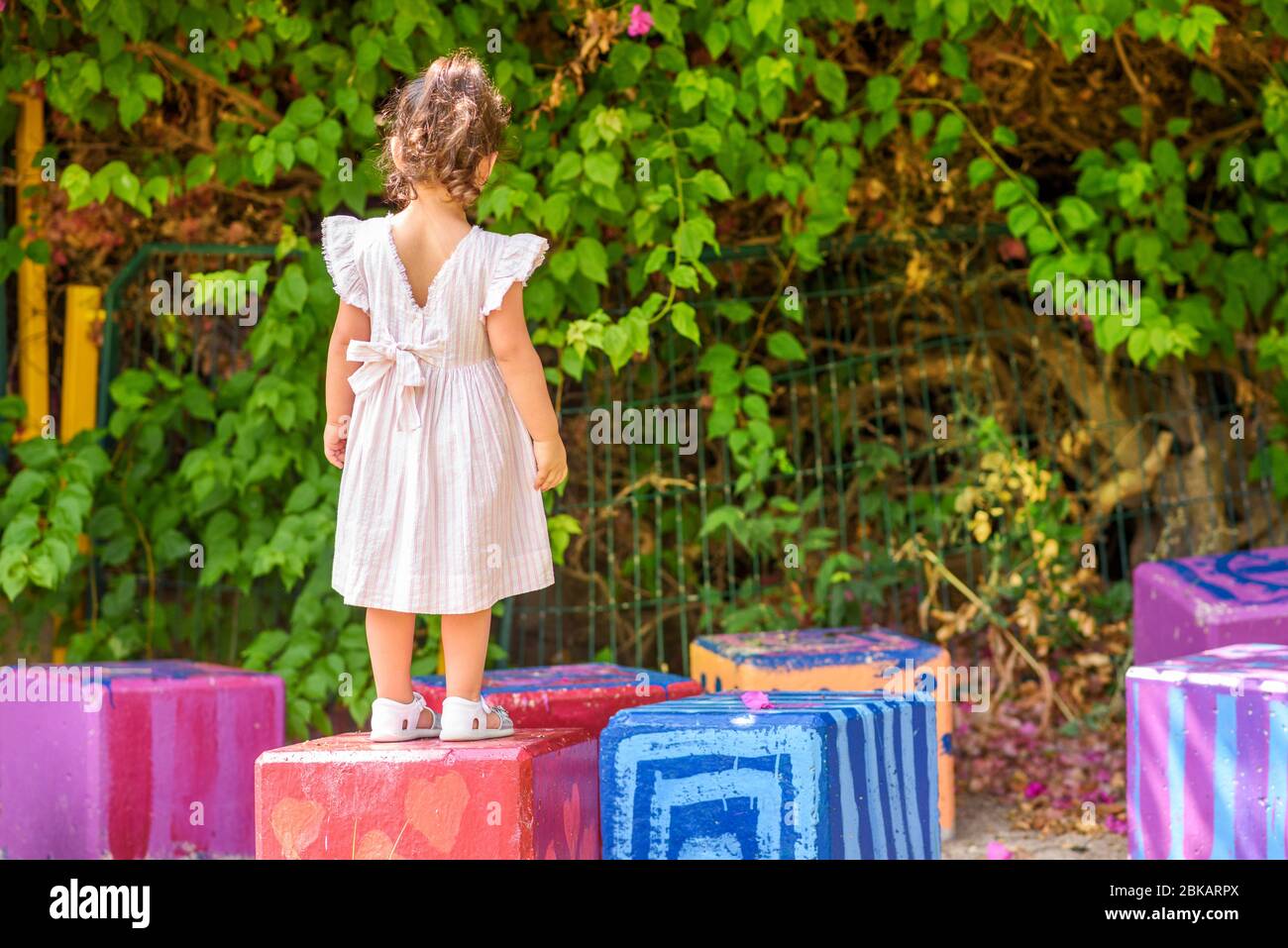 Preschool cute little girl training balance in the playground. Toddler ...
