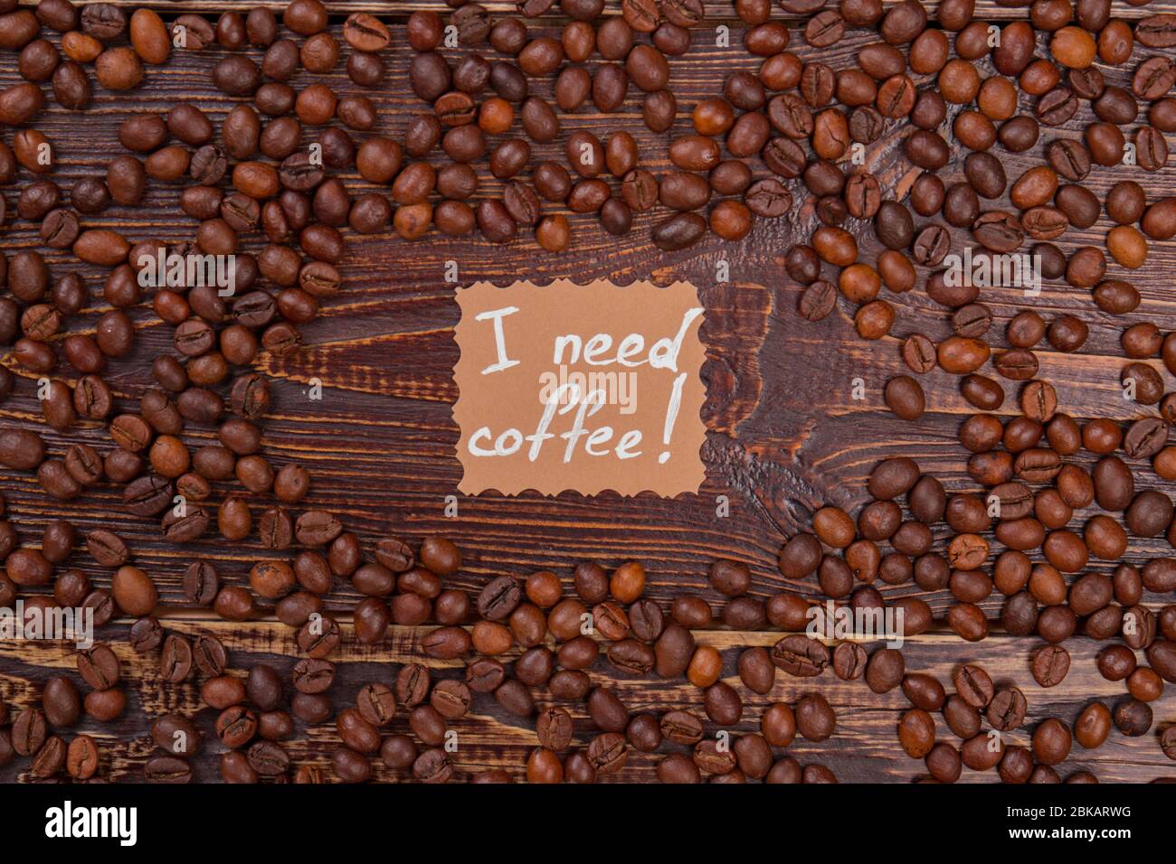 Paper with I need coffee lettering and coffee beans Stock Photo - Alamy