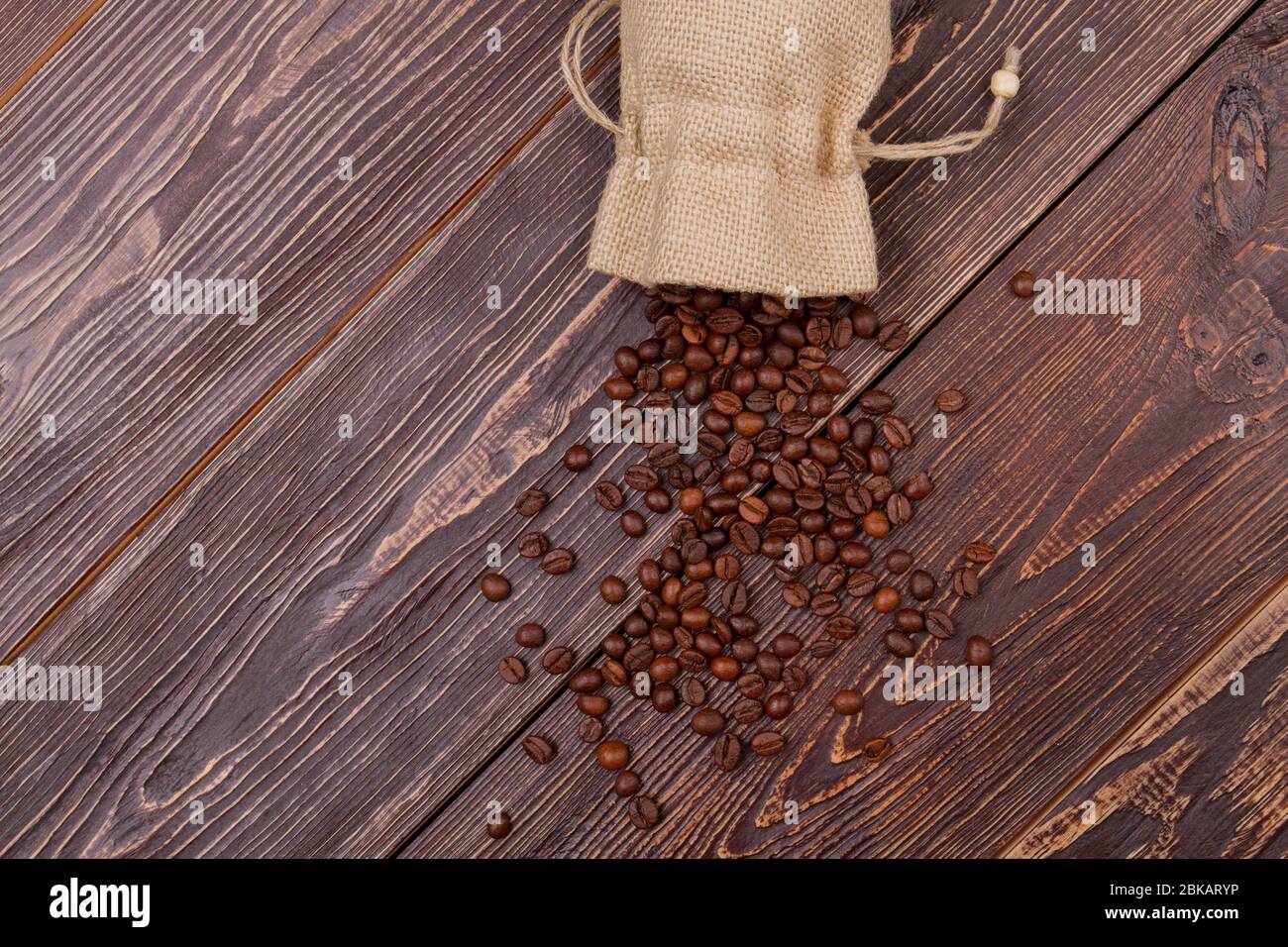 Spilled out coffee beans out of sack Stock Photo - Alamy