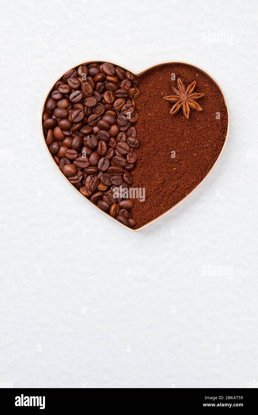 Heart made of coffee beans and powder isolated on white Stock Photo - Alamy
