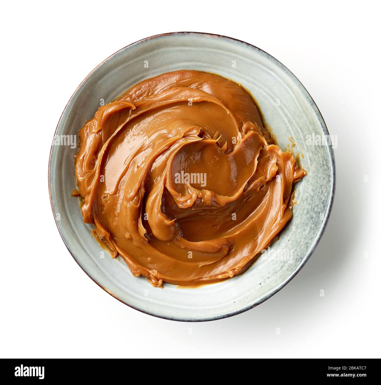 bowl of melted caramel isolated on white background, top view Stock ...