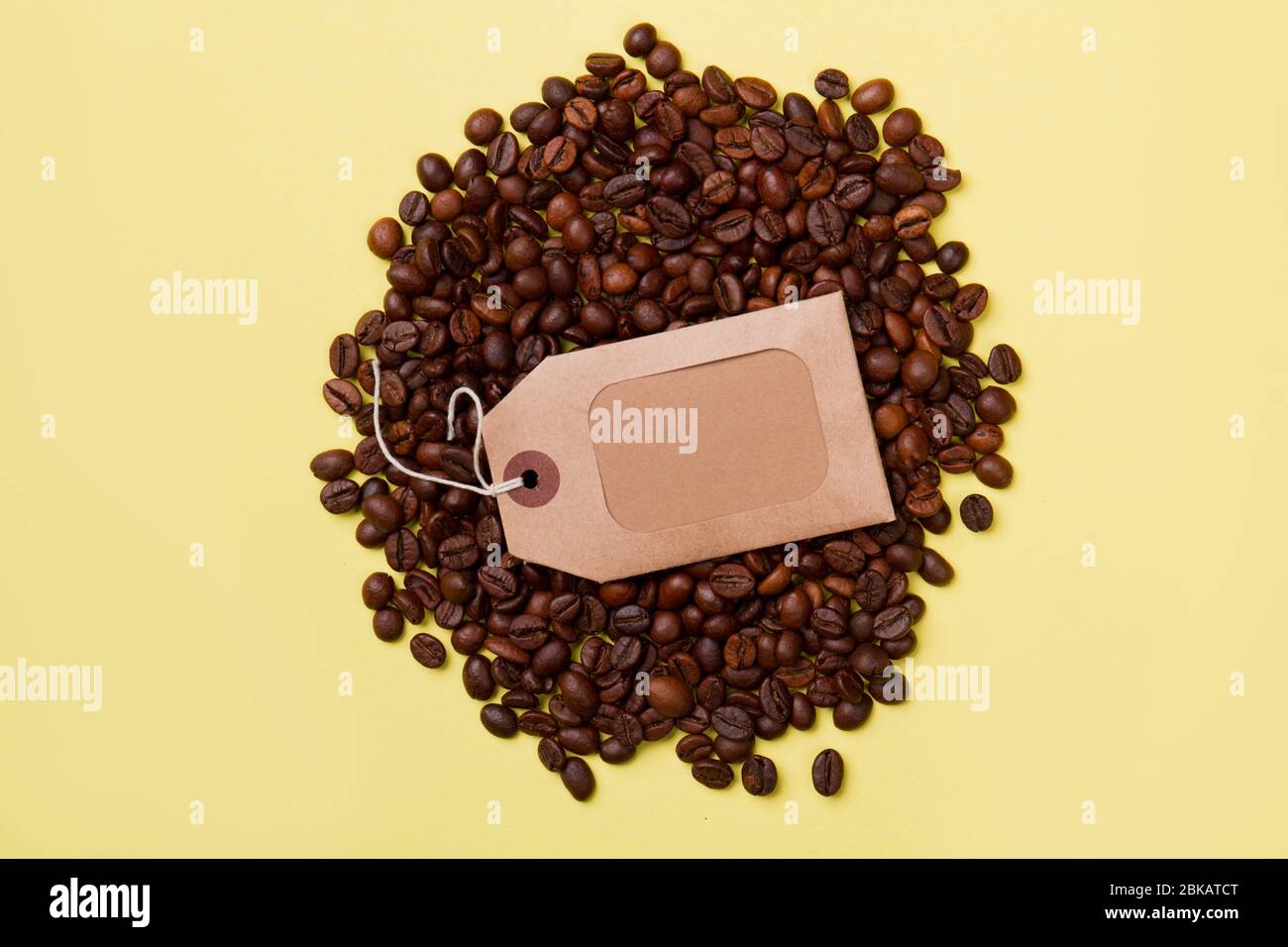 Coffee beans and blank paper tag Stock Photo - Alamy