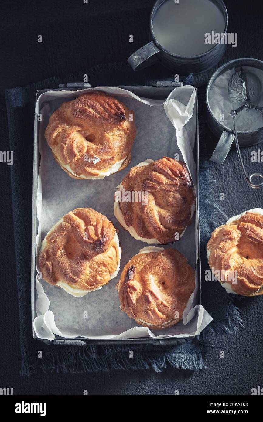 Yummy and sweet cream puffs with powdered sugar Stock Photo - Alamy