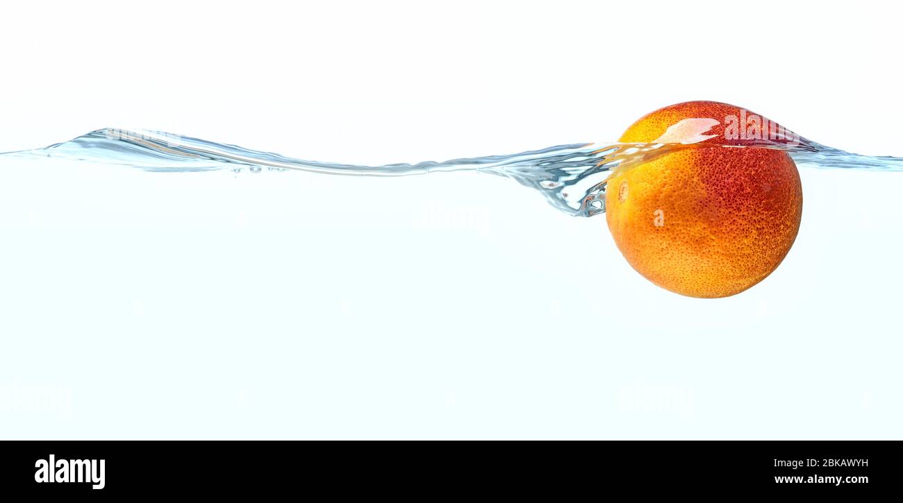 colorful orange fruit floating in water Stock Photo - Alamy