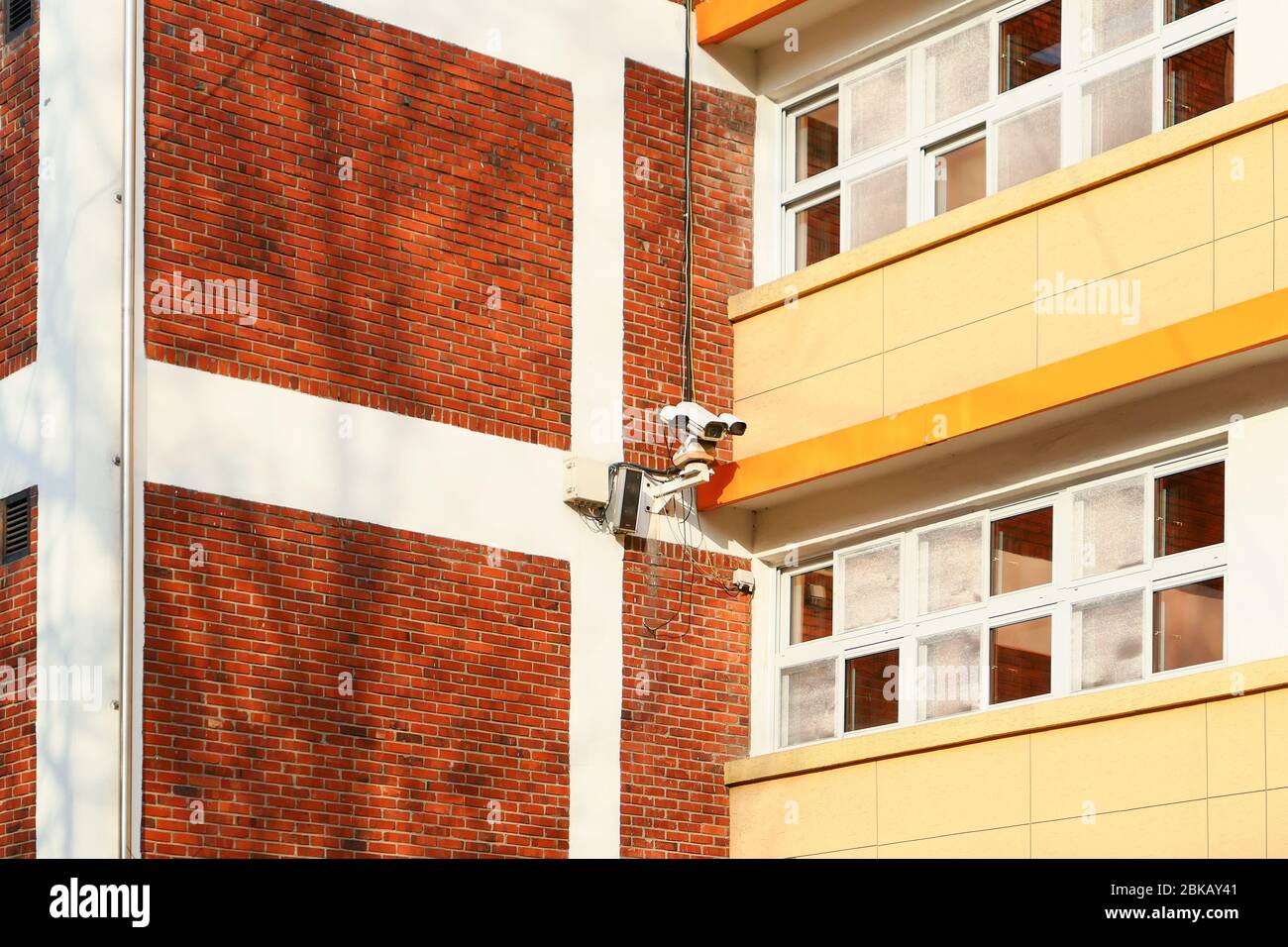 Surveillance camera on the wall of school building for prevention of ...