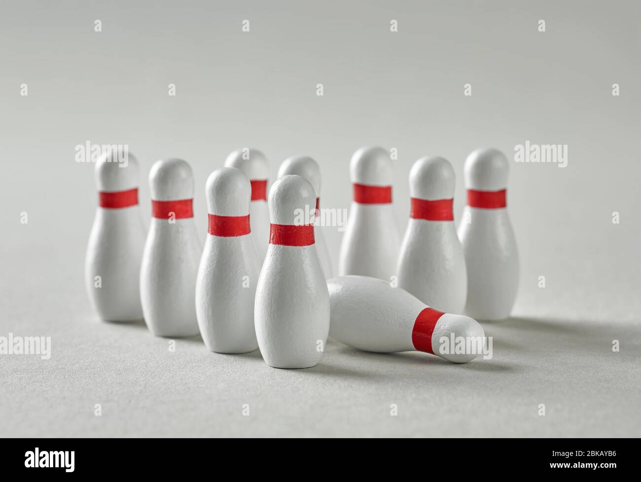 bowling pins triangle on grey paper background Stock Photo - Alamy