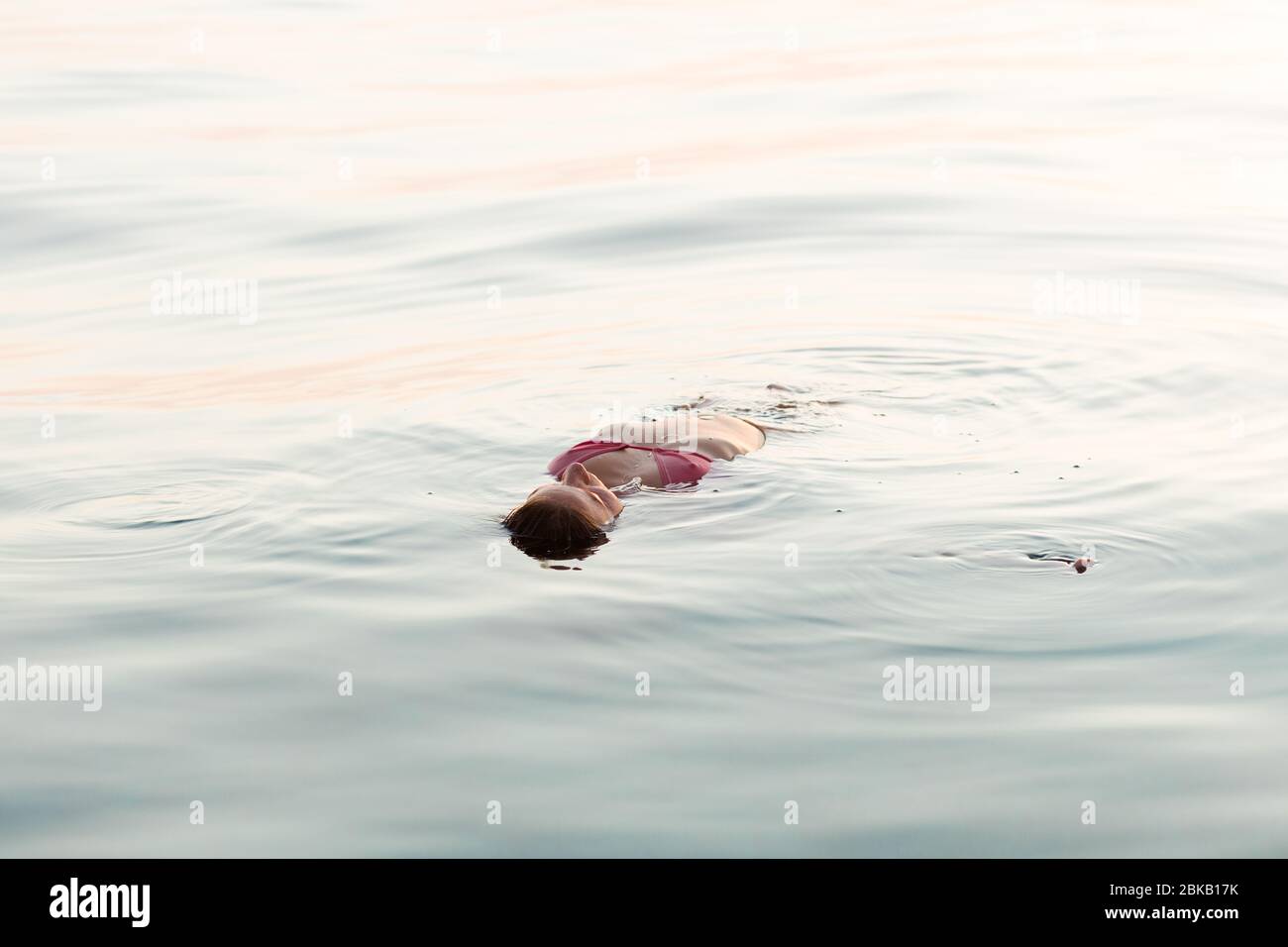 Young woman lying in water hi-res stock photography and images - Alamy