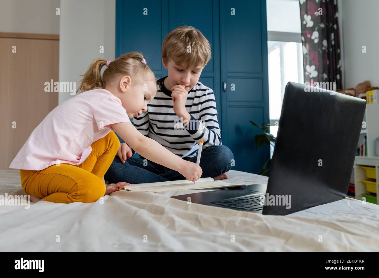 Boy girl doing homework laptop hi-res stock photography and images - Alamy