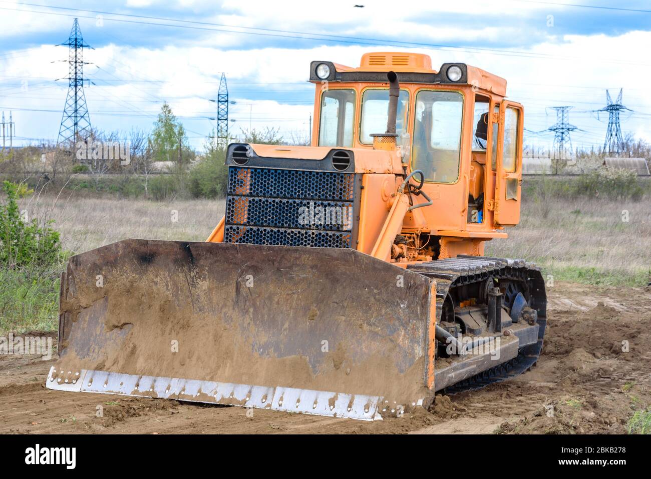Industrial building construction site bulldozer leveling and moving ...