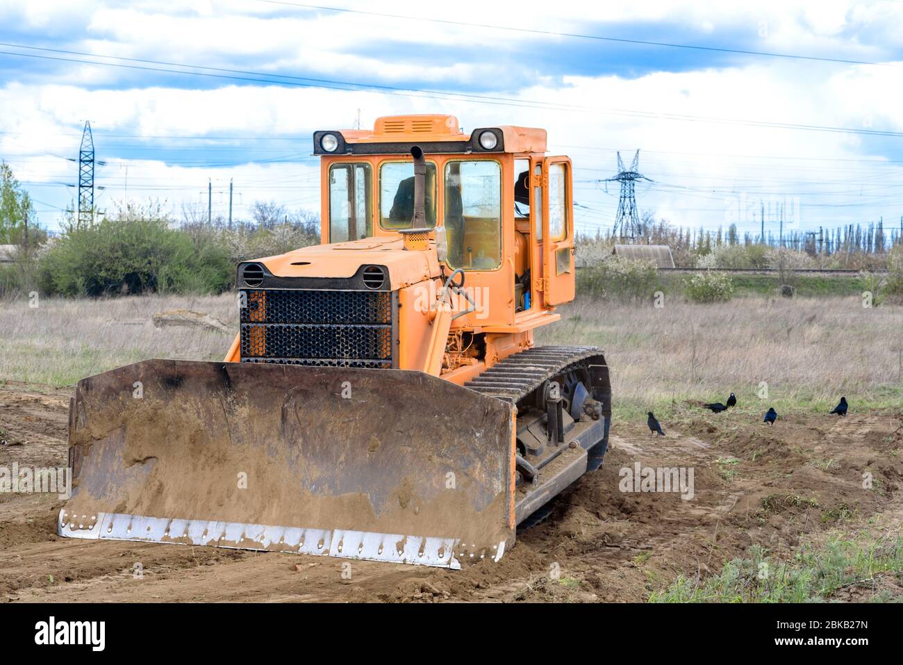 Industrial building construction site bulldozer leveling and moving ...