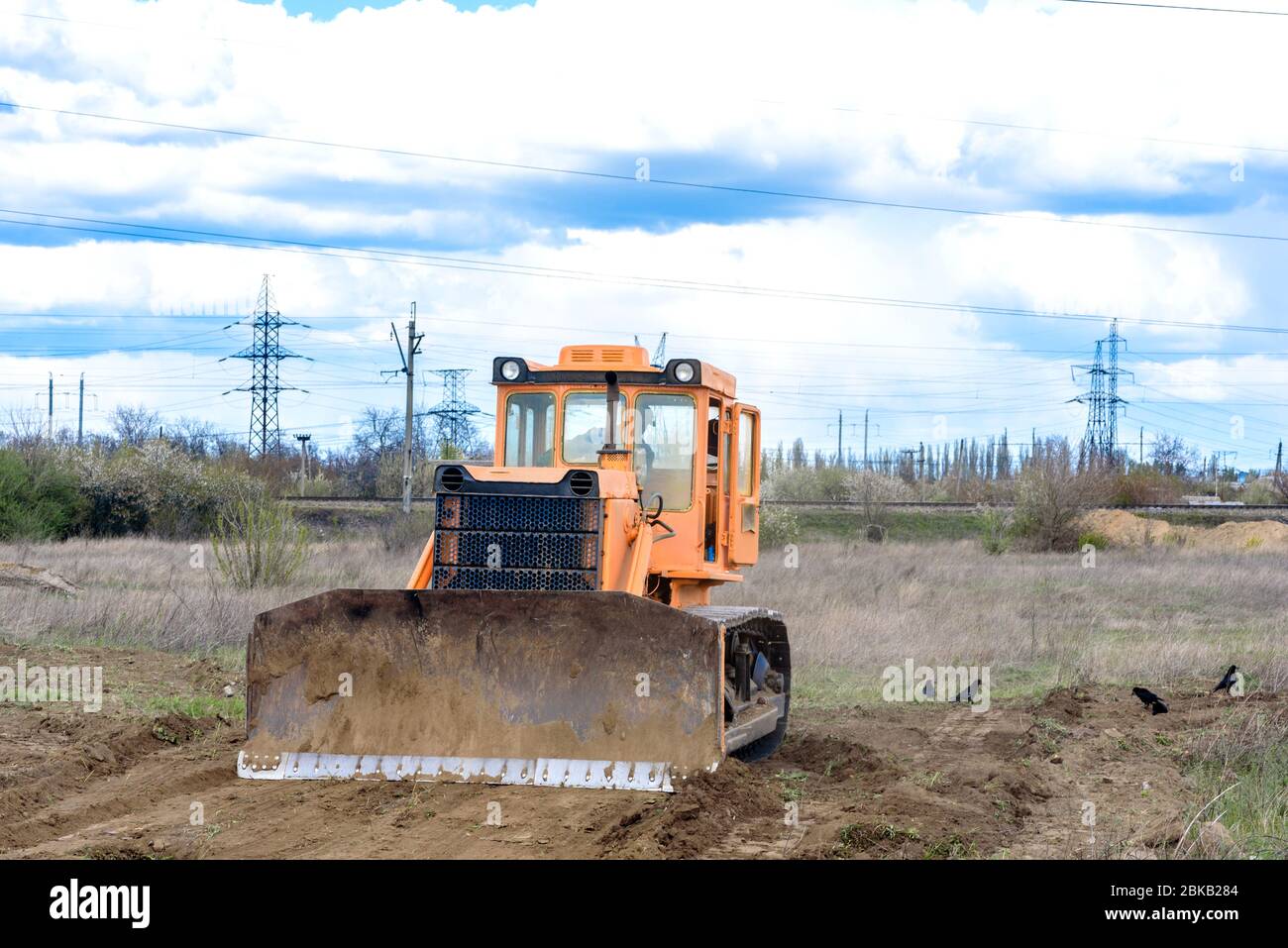 Industrial building construction site bulldozer leveling and moving ...