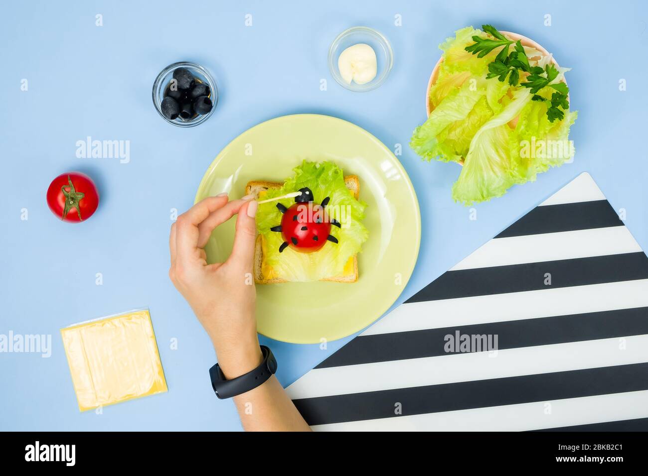 Fun food art for kids. Ladybug sandwich on blue background. How to make ...