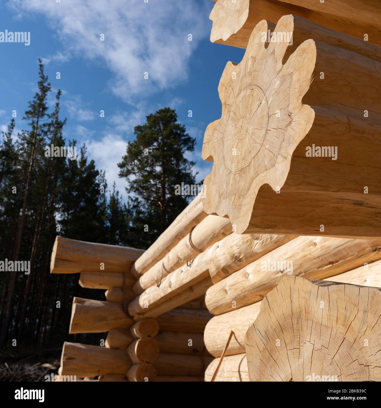 Making ethnic log houses in the open Stock Photo - Alamy