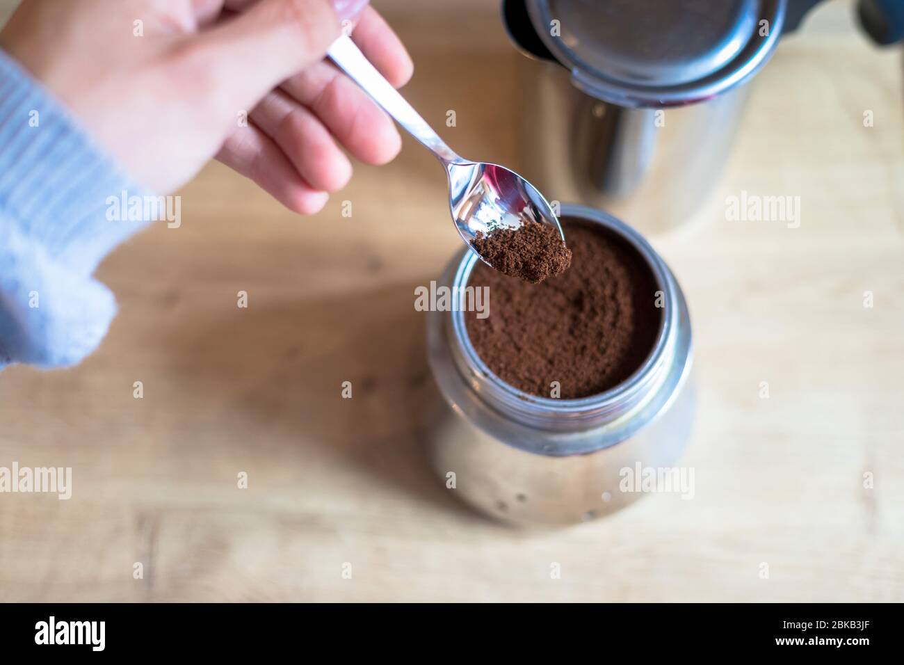 Preparing coffee: Close up of coffee powder in a vintage coffee cooker ...