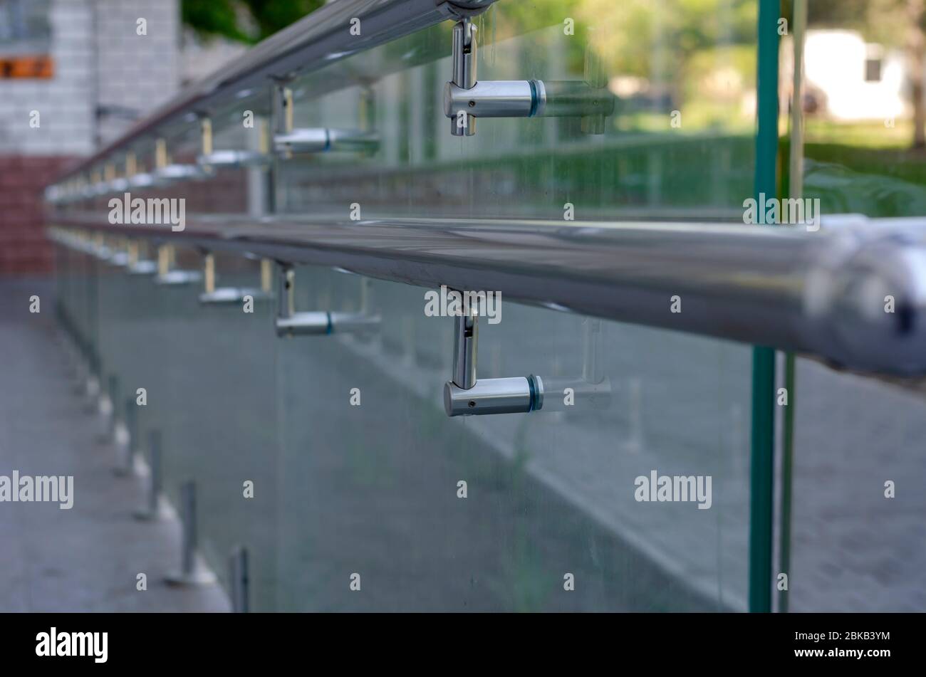 Glass railing for disabled people with chrome handrails. External ...