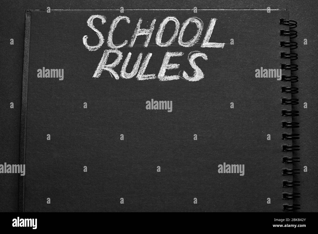 School rules word written on a notepad with blank space. Blank black ...