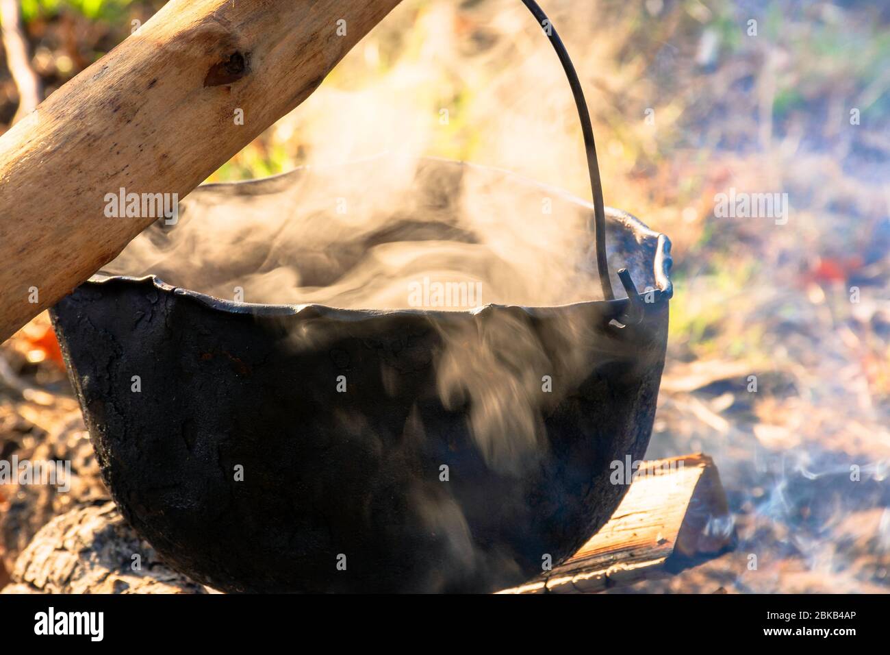 steaming old pot outdoor. cooking and camping. outdoor adventures ...