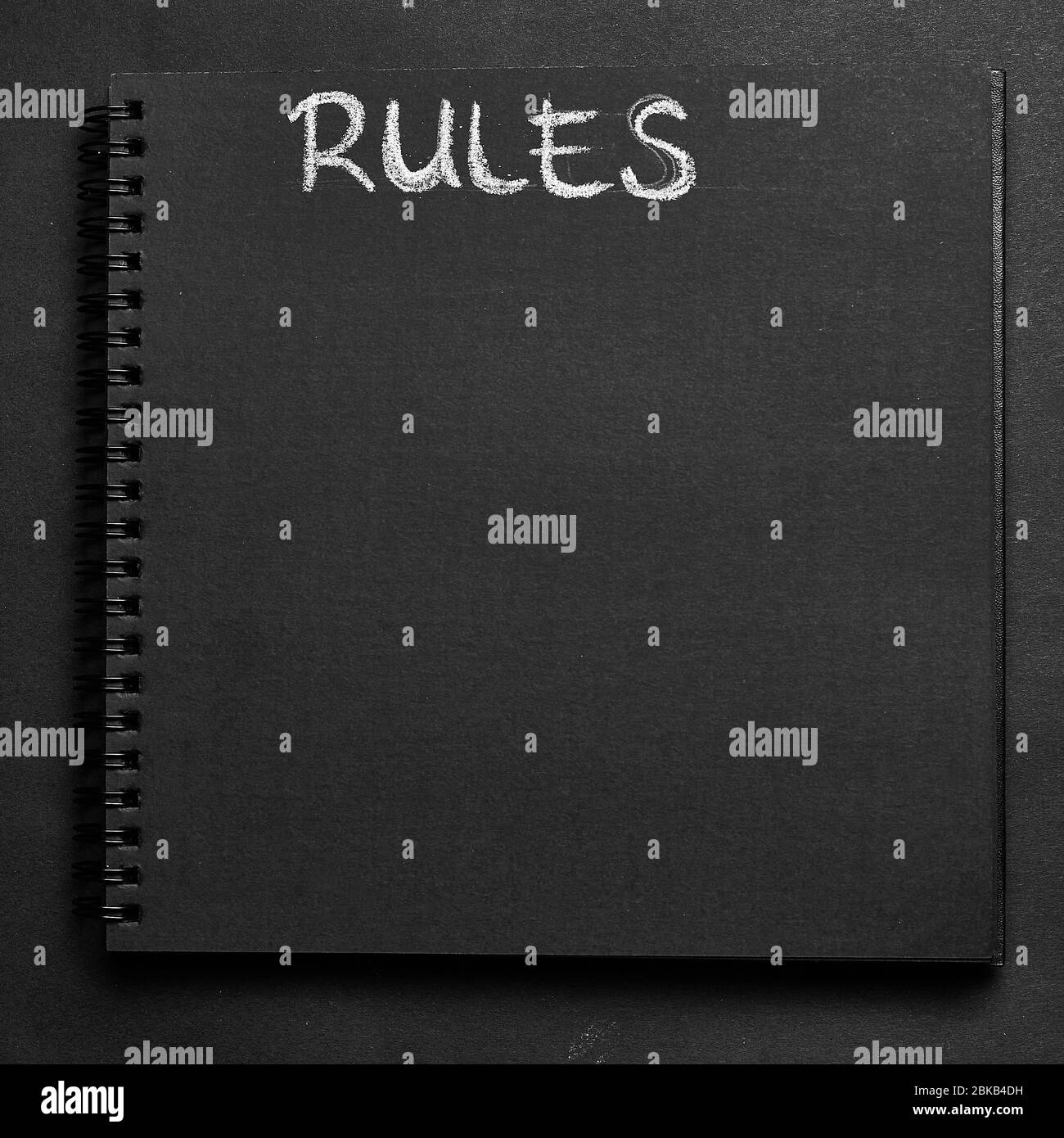 Rules word written on a notepad with blank space. Blank black notepad ...