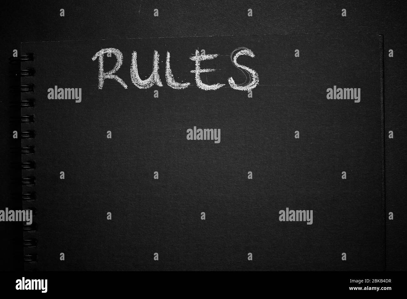 Rules word written on a notepad with blank space. Blank black notepad ...
