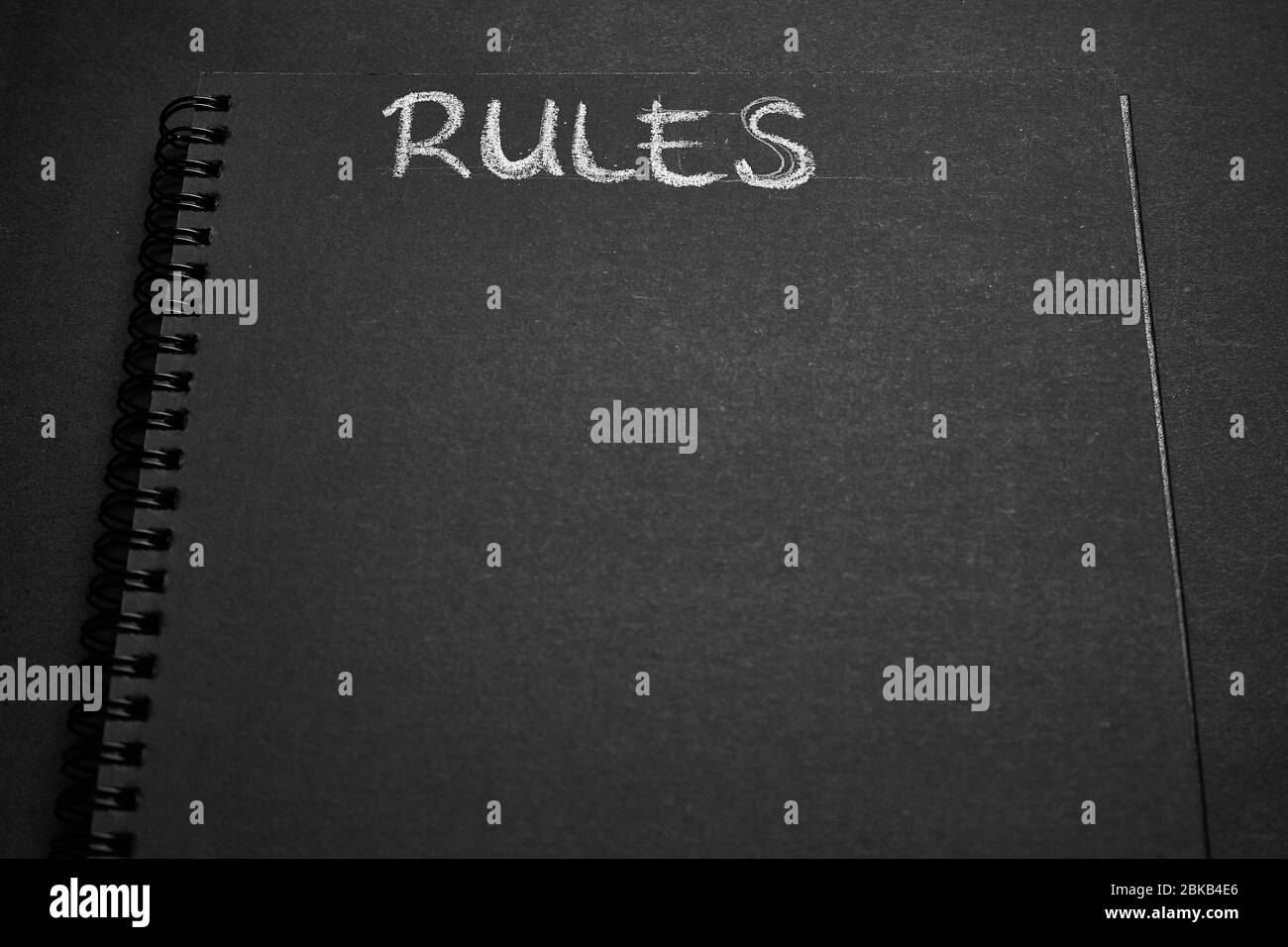 Rules word written on a notepad with blank space. Blank black notepad ...