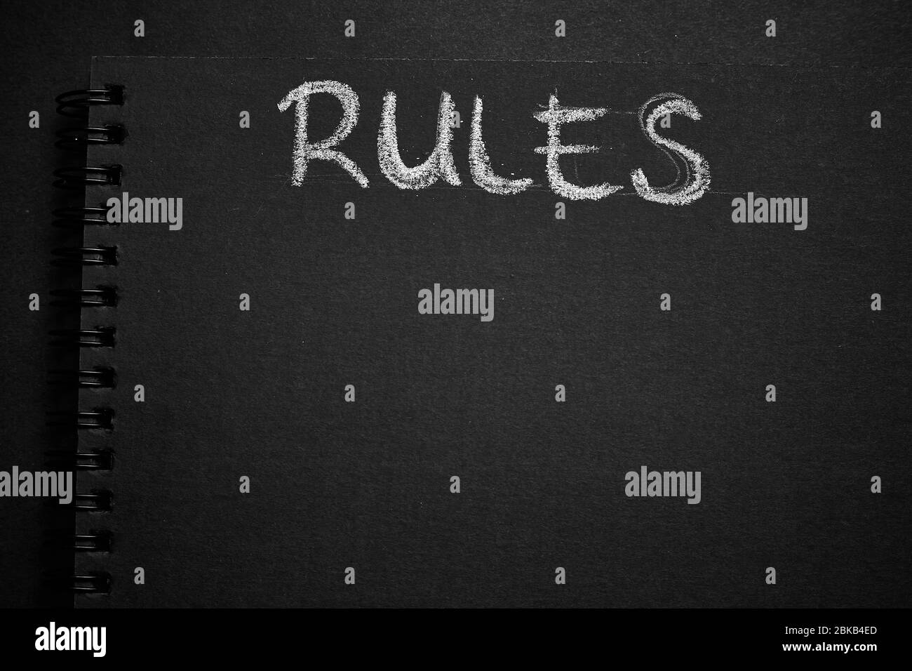 Rules word written on a notepad with blank space. Blank black notepad ...